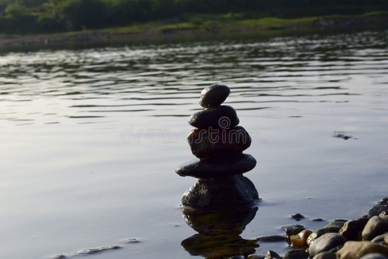A Stone Pyramid in the Water by the River Stock Image - Image of stack ...
