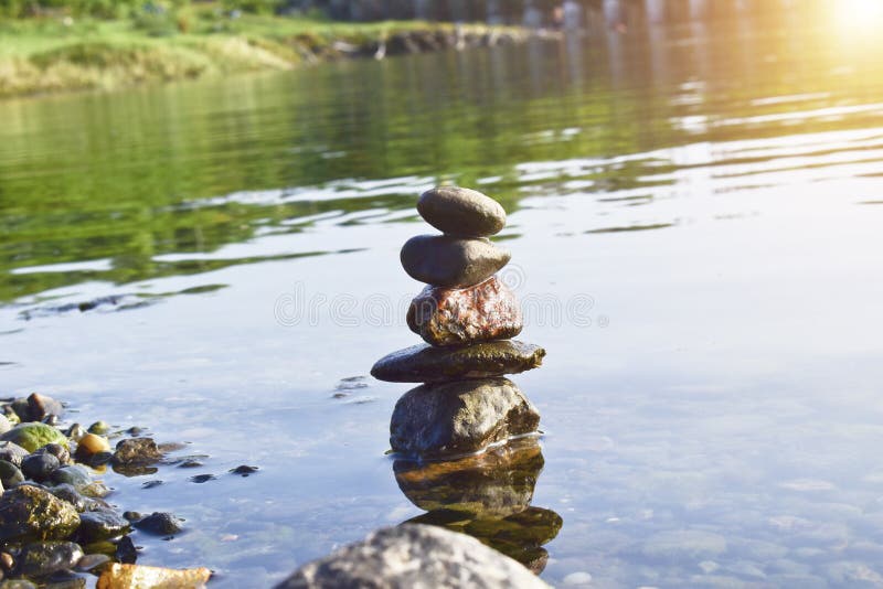 A Stone Pyramid in the Water by the River Stock Photo - Image of close ...