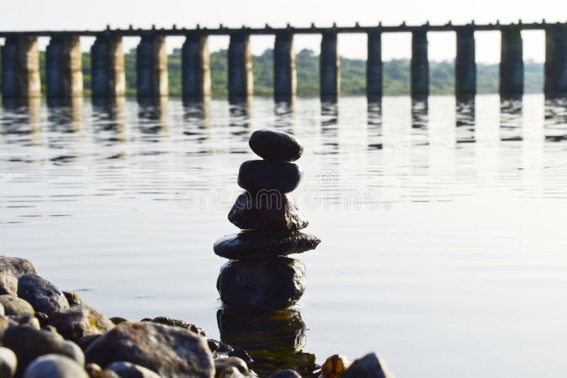 A Stone Pyramid in the Water by the River Stock Photo - Image of blue ...
