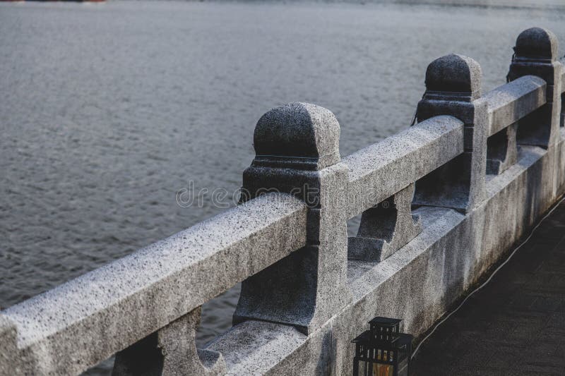 Stone Railing Along a Peaceful Waterfront Walkway Stock Image - Image ...