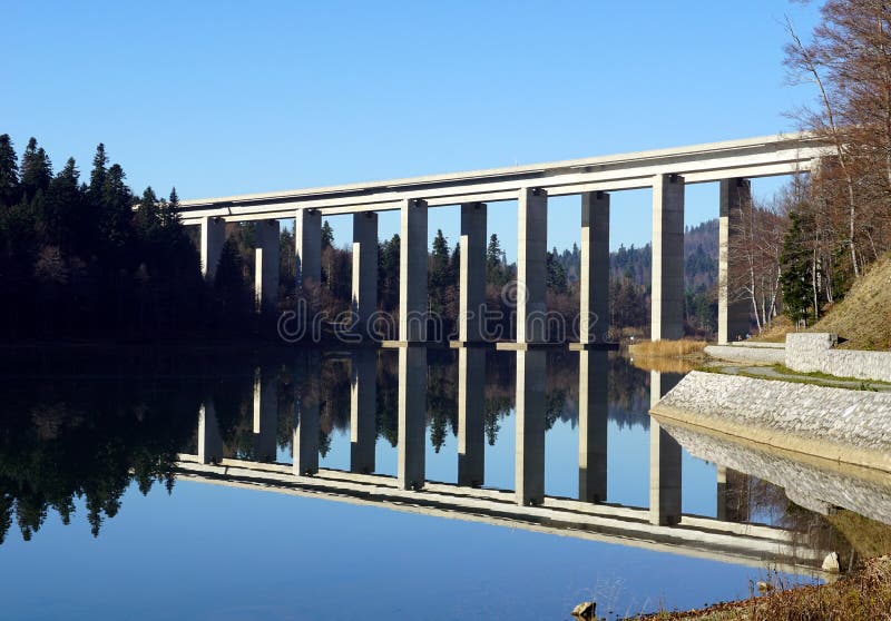 Stone Road Overpass Over the Lake and Reflections in the Water Stock ...