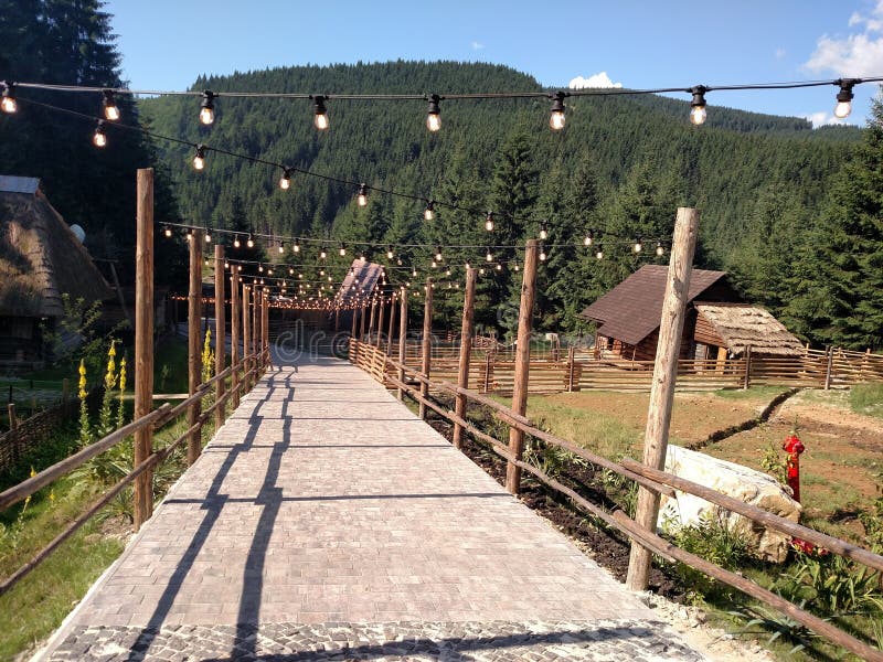 Stone Road Under Garlands of Lamps Overlooking Mountain Forest Stock ...