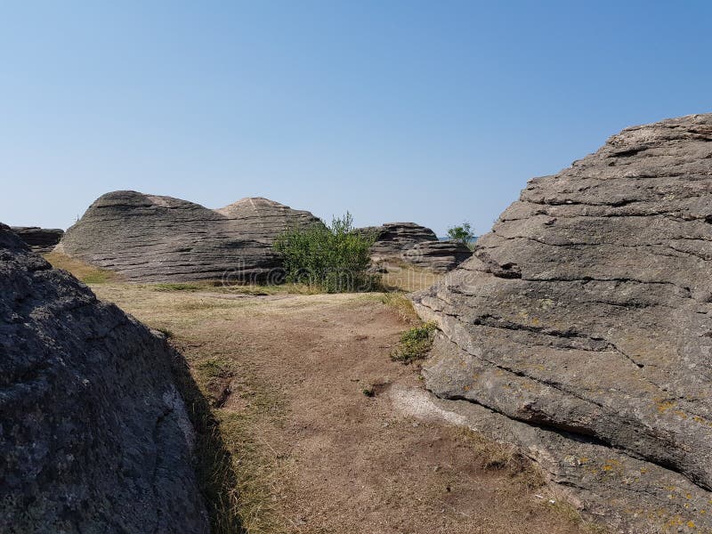 Stone rocks in the steppe stock photo. Image of cliff - 192264364