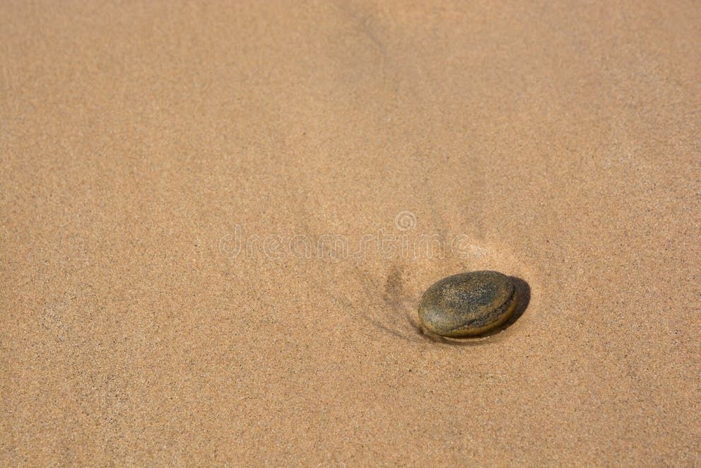 Stone on a sandy beach stock image. Image of defy, sand - 35281003