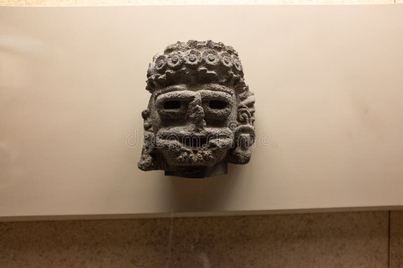 A Stone Sculpture of a Human Face with Large Rectangular Eyes. British ...