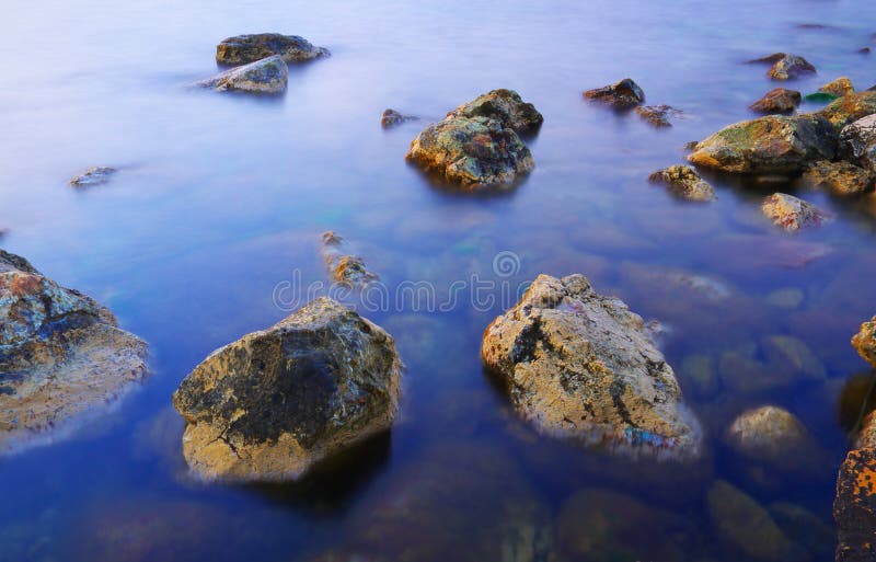Stone in sea stock image. Image of outdoors, clear, sunlight - 13903981