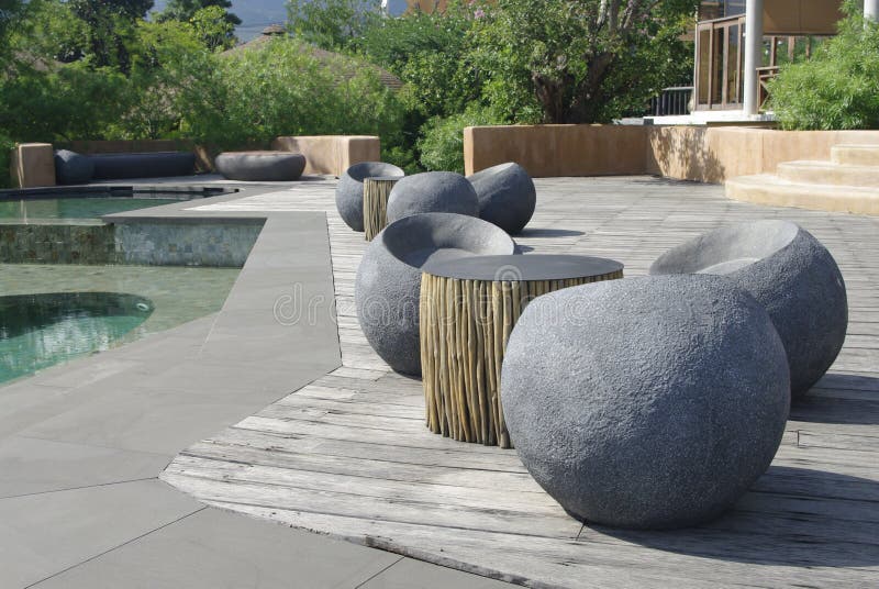 Stone Seating Next To Swimming Pool Stock Image - Image of blue, nature ...