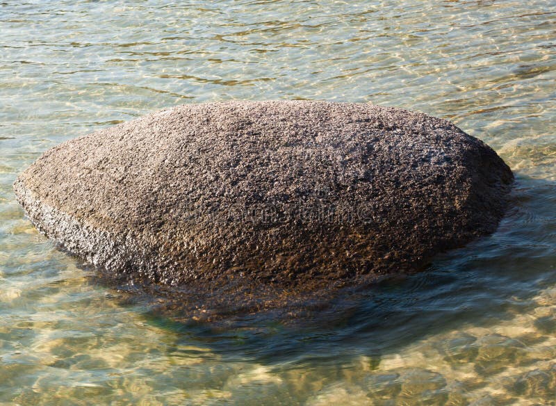 Stone in shallow water stock photo. Image of background - 265453968