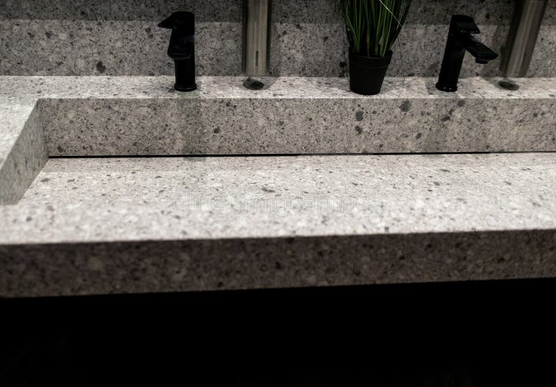 Stone sink and two faucets stock photo. Image of interior - 278056624