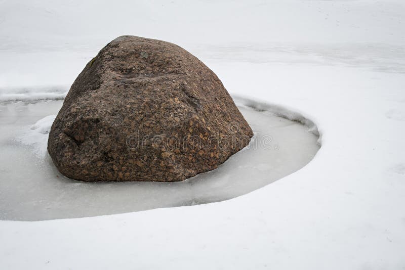 The Stone in the Snow Melts the Snow Around Him. Stock Photo - Image of ...