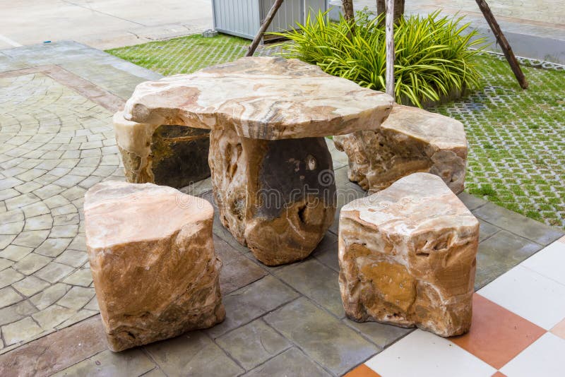 Stone table set in garden stock image. Image of outside - 131808555