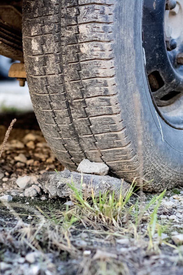 Stone Under a Car Wheel in the Grass Stock Photo - Image of yellow ...
