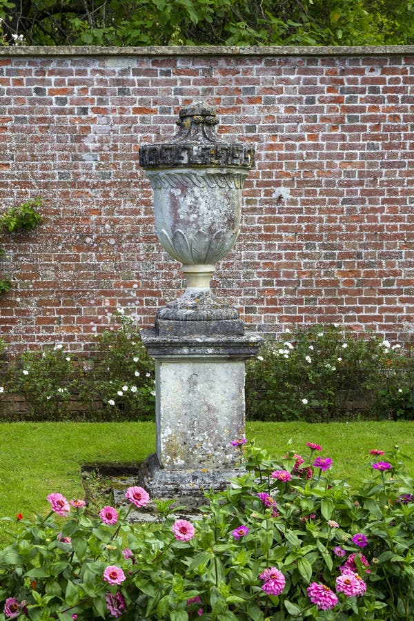 Stone Urn in Green Lawn Against Red Brick Wall Editorial Image - Image ...