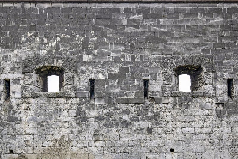 Stone Wall of an Ancient Castle with Windows in the Form of Loopholes ...