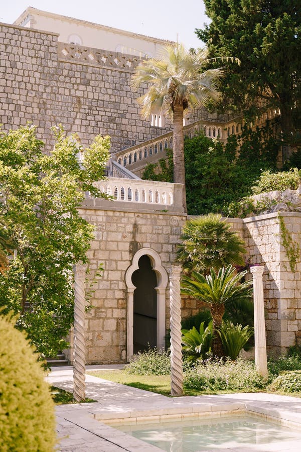 The Stone Wall of the Building with a White Staircase with Columns ...