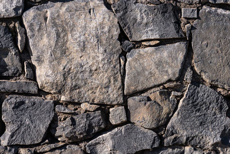 Stone Wall Built with Grunge Relief Granite Rock. Stock Photo - Image ...