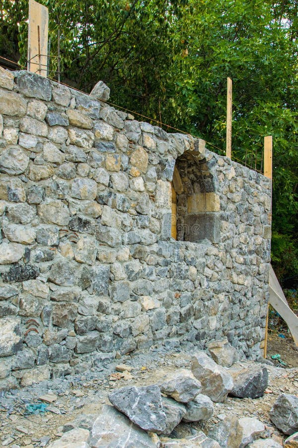 Stone Wall during Construction Stock Photo - Image of stone, handcart ...