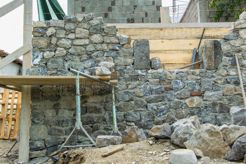 Stone Wall during Construction and Masonry Tools Stock Photo - Image of ...