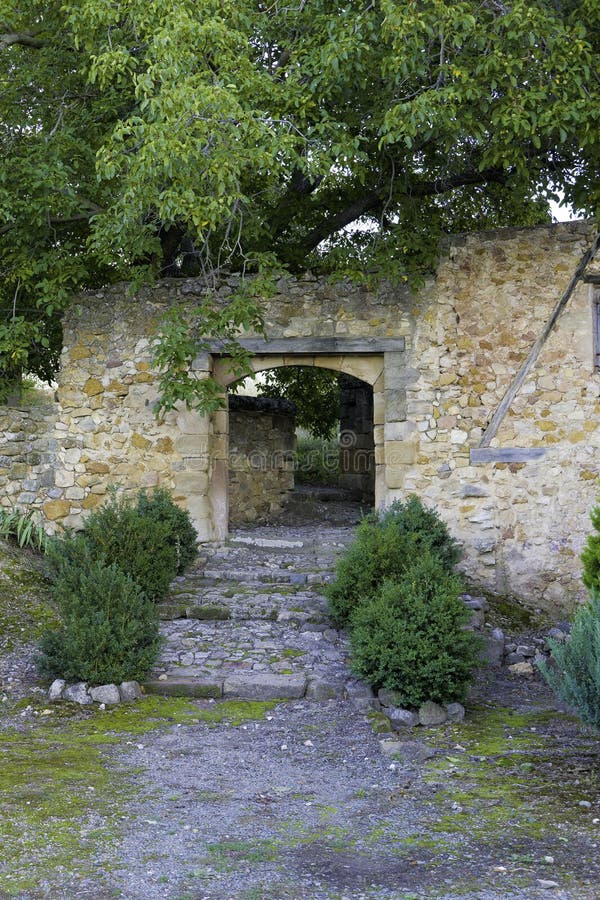 A Stone Wall with a Door and a Path Leading To it Stock Image - Image ...