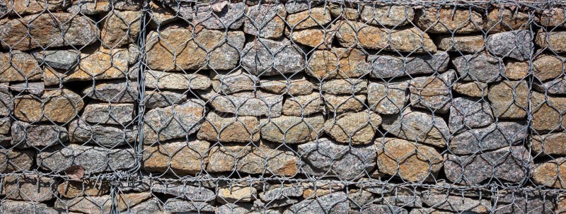 Stone Wall in a Metal Grid As a Background Stock Photo - Image of ...
