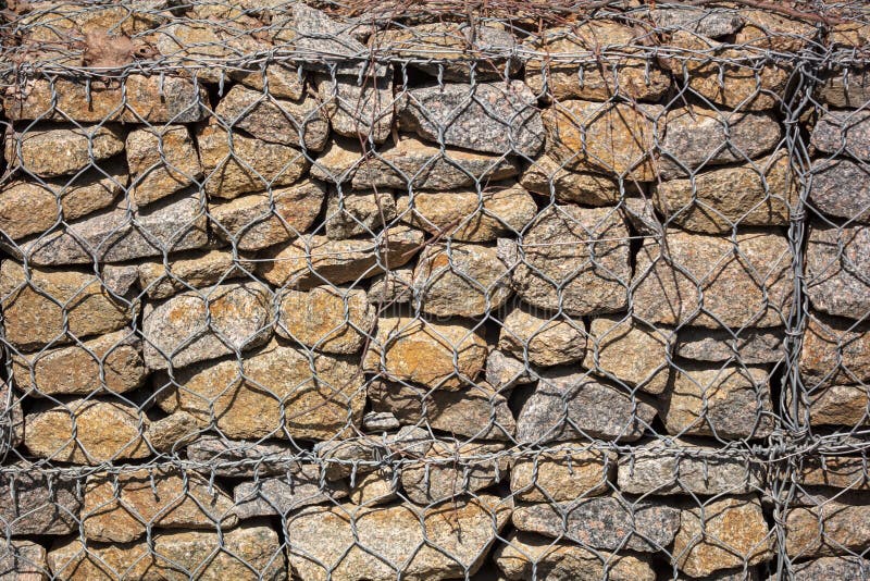 Stone Wall In A Metal Grid As A Background Stock Photo - Image of ...