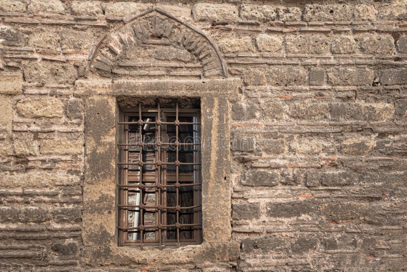 Stone Wall of an Old Building, with a Grate on the Window Stock Photo ...