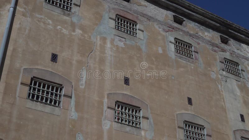 Prison Building Wall with Barred Windows of Prison Cells Behind an Iron ...