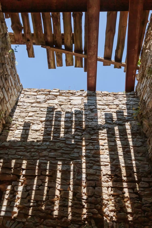 Sunlit Stone Wall with Shadows of Wooden Beams Stock Photo - Image of ...
