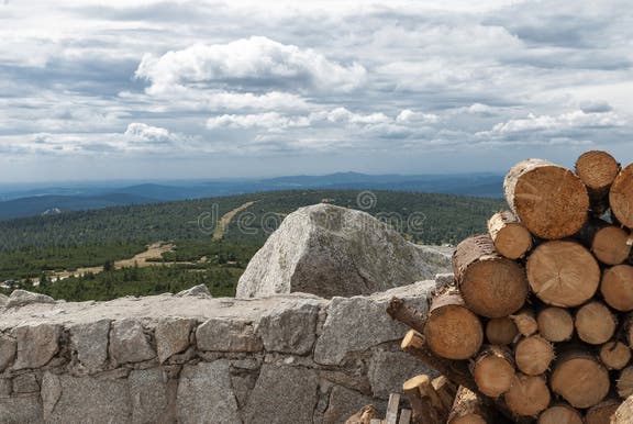 Stone Wall and Tree Trunks Against the Background of Mountain Space ...