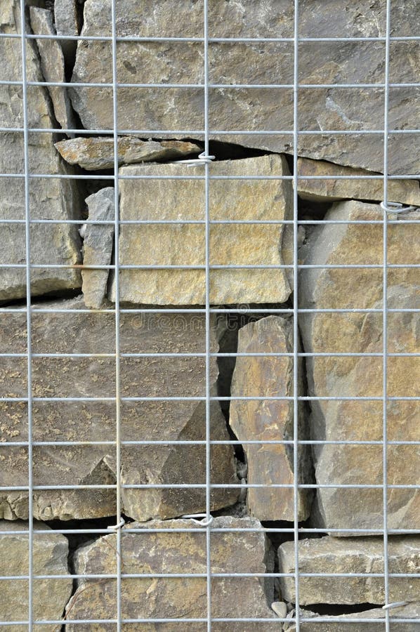 Stone Wall in the Wire Reinforcement Stock Image - Image of small ...