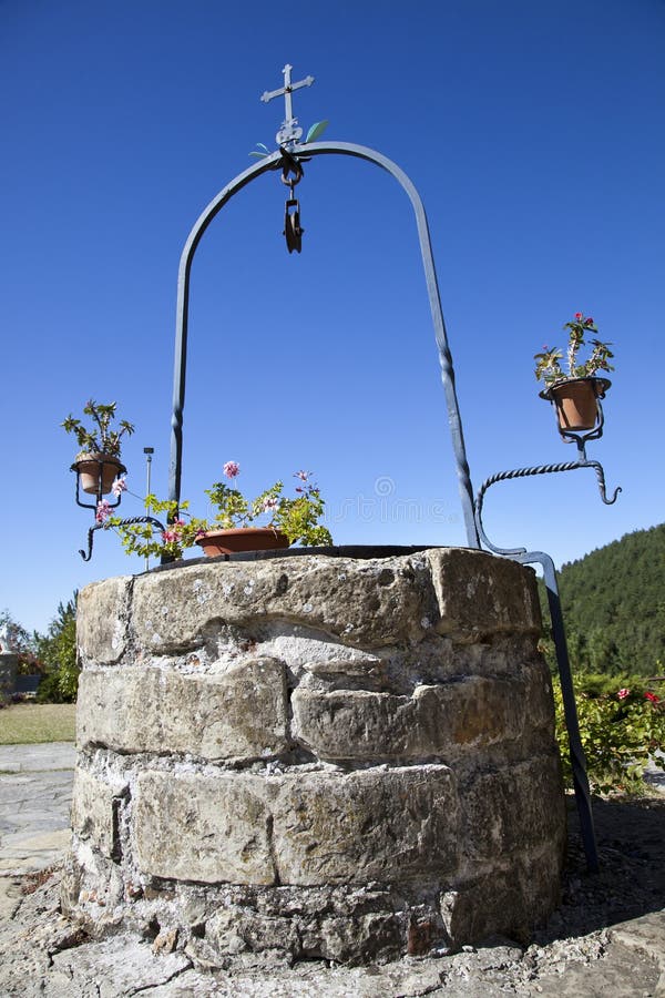 A stone well in the garden stock image. Image of elegant - 22823623