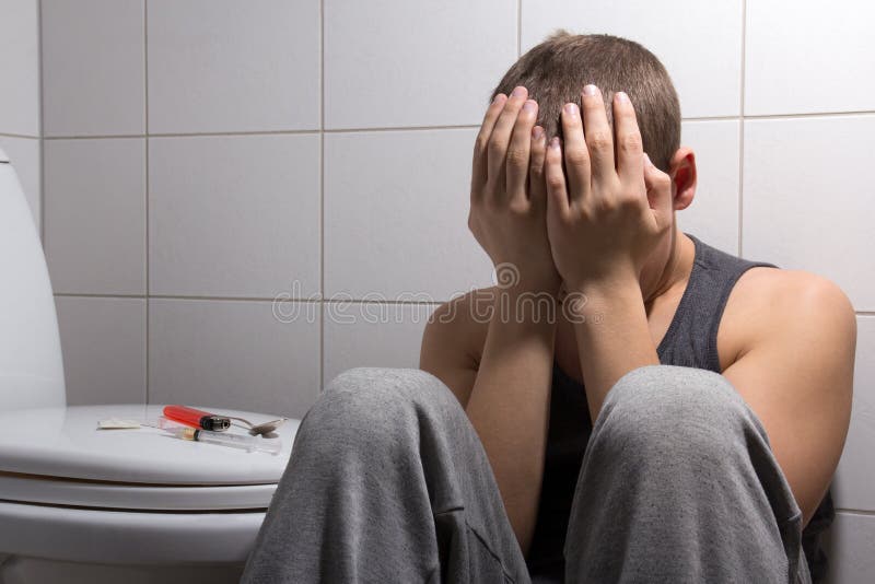 Stoned Man with Heroin Addiction Sitting in Bathroom Stock Photo ...