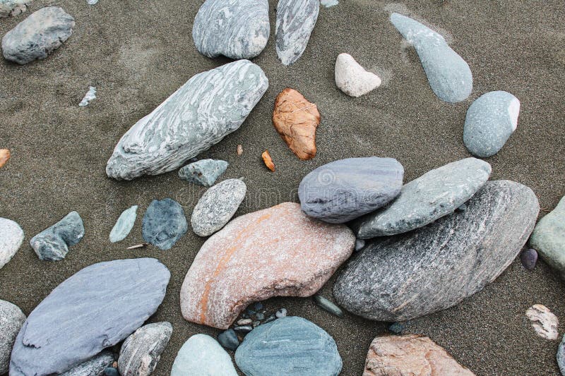 Stones of Different Breeds and Colors Lie in the Sand Stock Photo ...