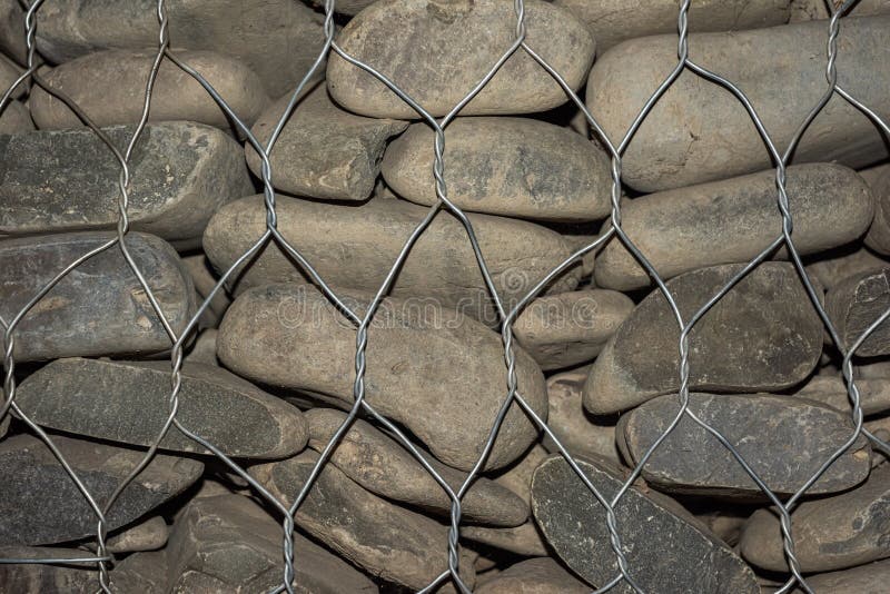 Stones in a metal grid stock image. Image of object - 168071993