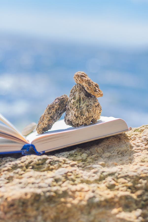 Stones on the Pages of an Open Book on the Seaside Stock Image - Image ...