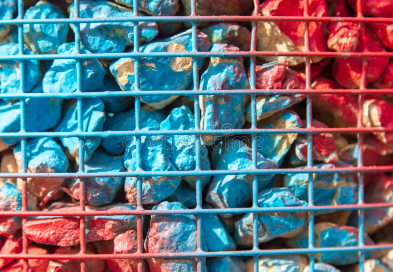 Stones Painted with Blue Paint in a Metal Grid As a Background Stock ...