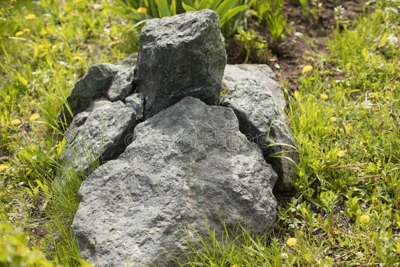 Stones in Park. Green Grass and Bunch of Stones Stock Image - Image of ...