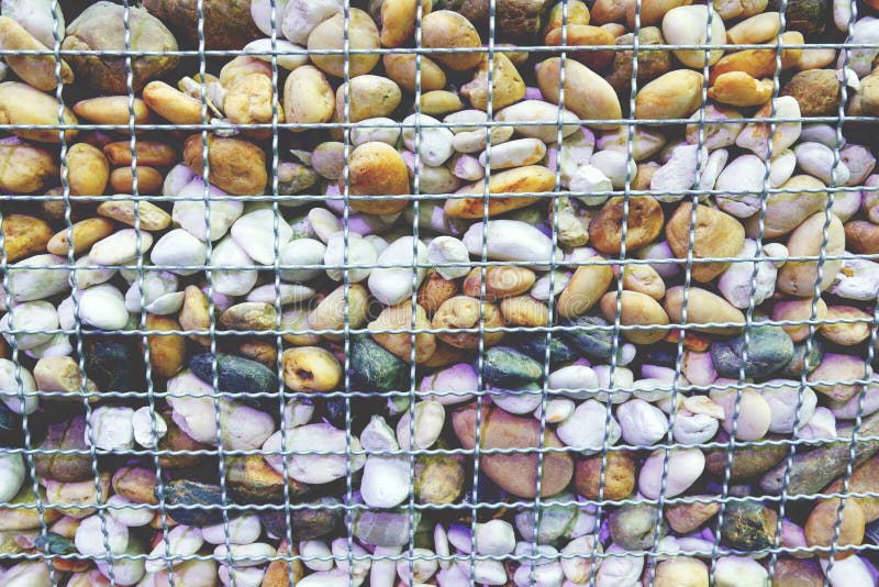 Stones and Pebbles Wall in Wire Mesh Stock Photo - Image of design ...