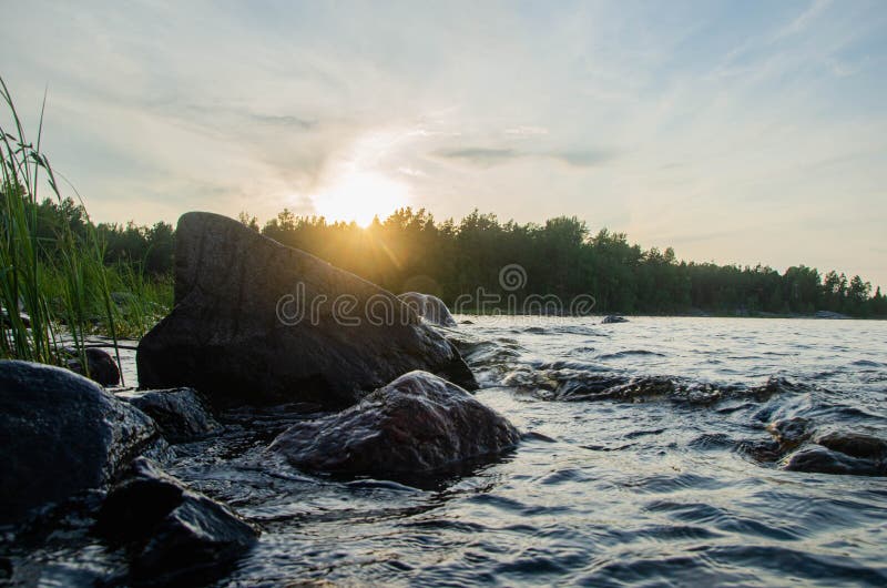 Stones in the rays of dawn stock photo. Image of shore - 238935526