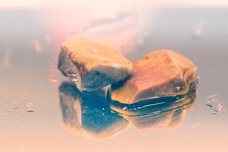 Beautiful Stones on a Reflective Surface Stock Photo - Image of orange ...