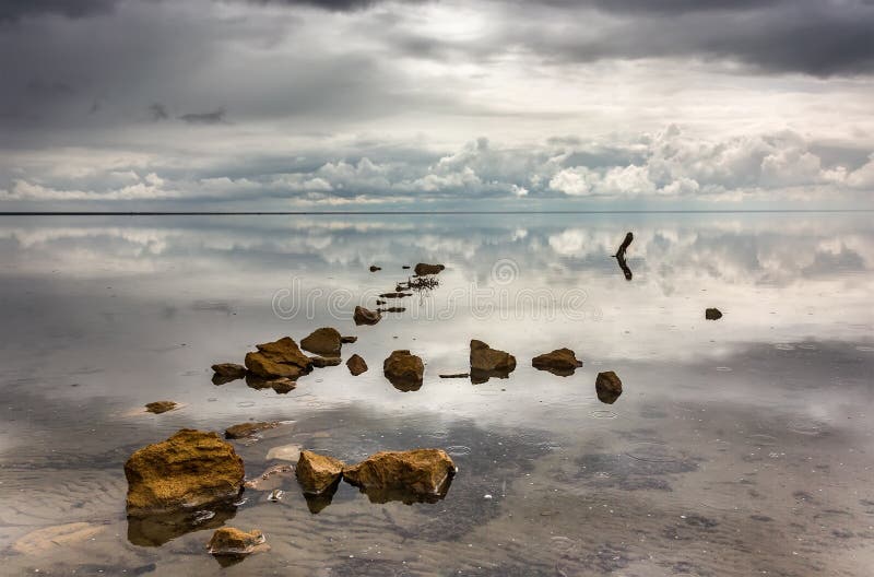 Stones and Reflection of the Sky in Salt Lake of Elton Stock Photo ...