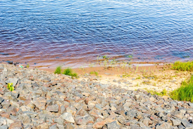 Stones on the river bank stock photo. Image of brick - 131508260