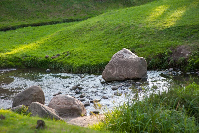 Stones in the River Interfere with the Flow of Water, the Lawn by the ...