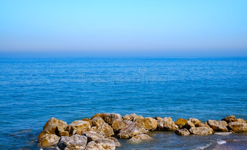 Stones on the seashore stock photo. Image of horizon - 149104854
