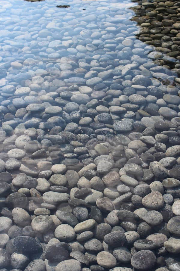 A Layer of Gray and Black Stones Covered in a Layer of Water Stock ...