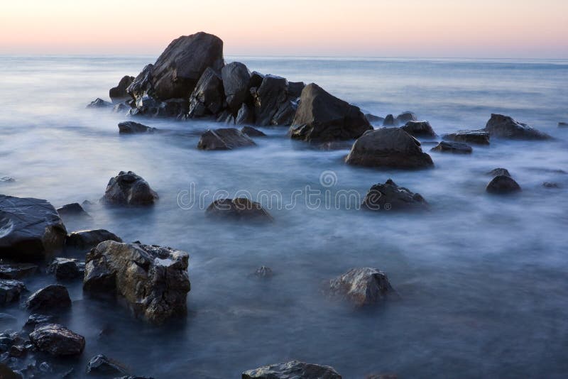 Stones in water in evening stock image. Image of horizontal - 16169163