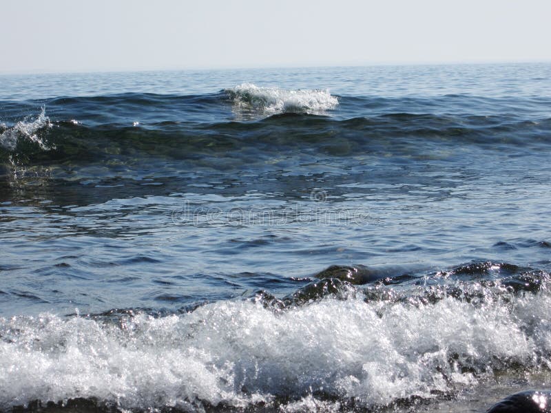 Stones in a Wave stock image. Image of superior, stone - 61283109