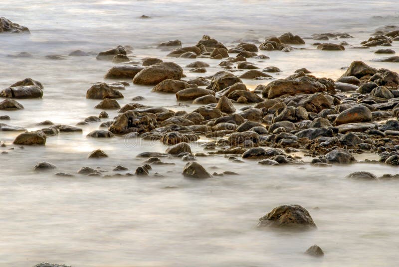 Stony surf at the ocean stock photo. Image of surf, blue - 148313568