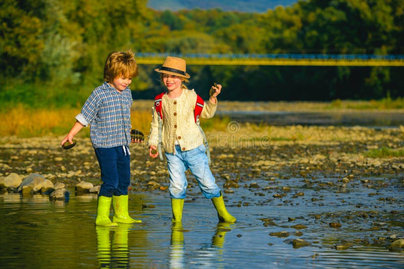 Stony River. Children Throwing Stones into the River after School ...
