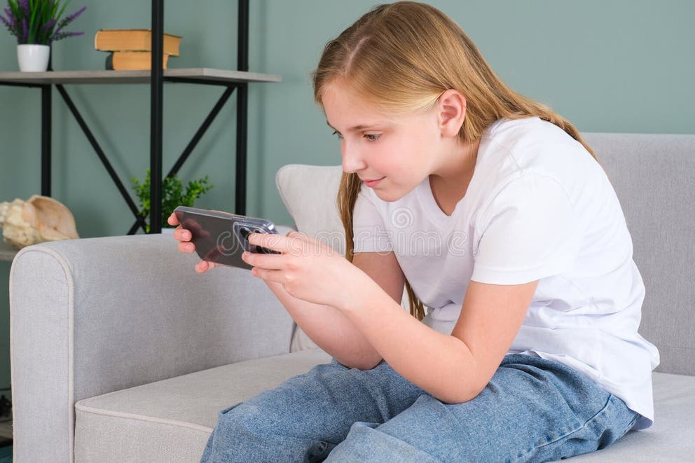 A Stooped Child Uses a Mobile Phone. Violation of Posture Stock Image ...